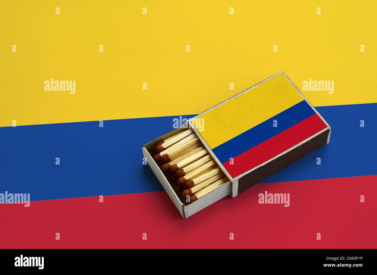 Colombia flag is shown in an open matchbox, which is filled with ...