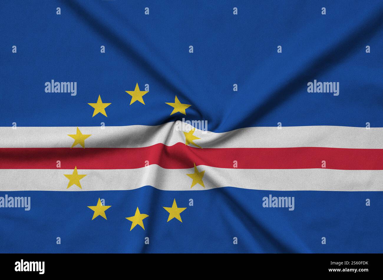 Cabo verde flag is depicted on a sports cloth fabric with many folds ...