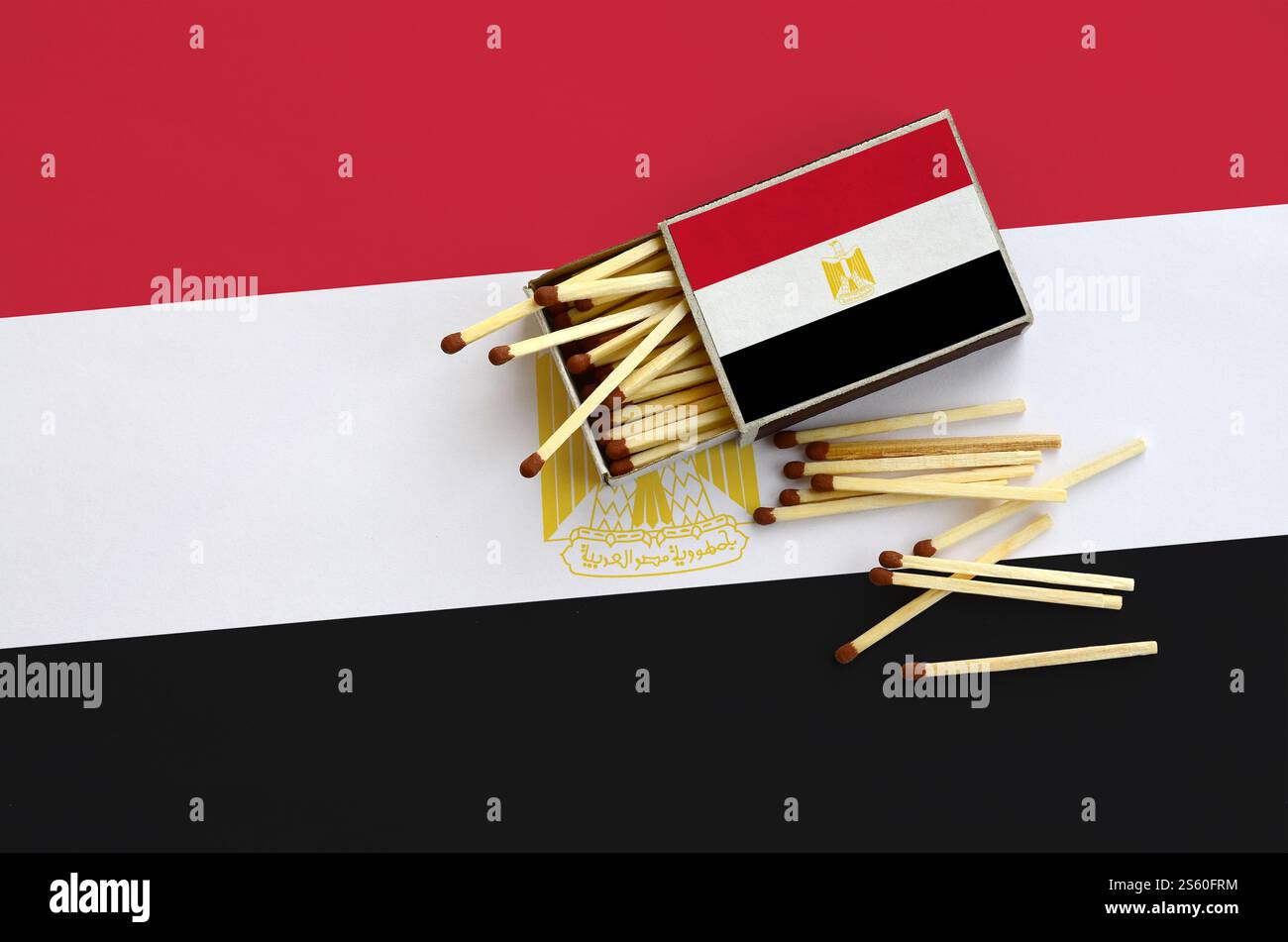 Egypt flag is shown on an open matchbox, from which several matches ...