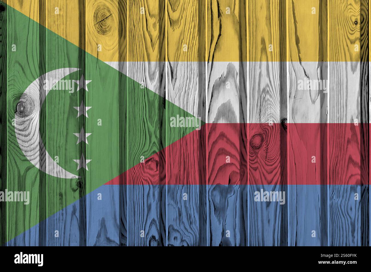 Comoros flag depicted in bright paint colors on old wooden wall close ...