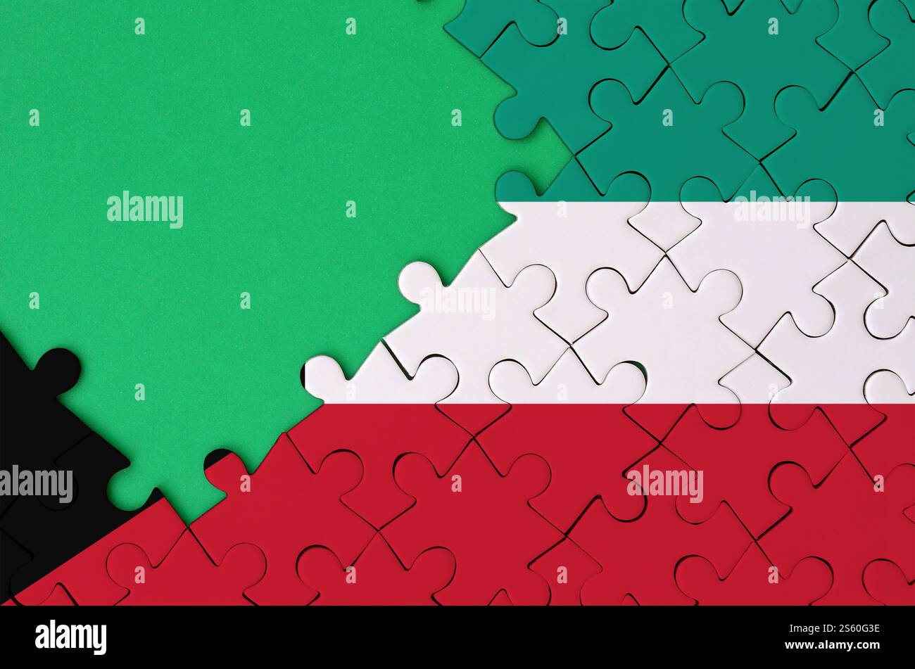 Kuwait flag is depicted on a completed jigsaw puzzle with free green ...
