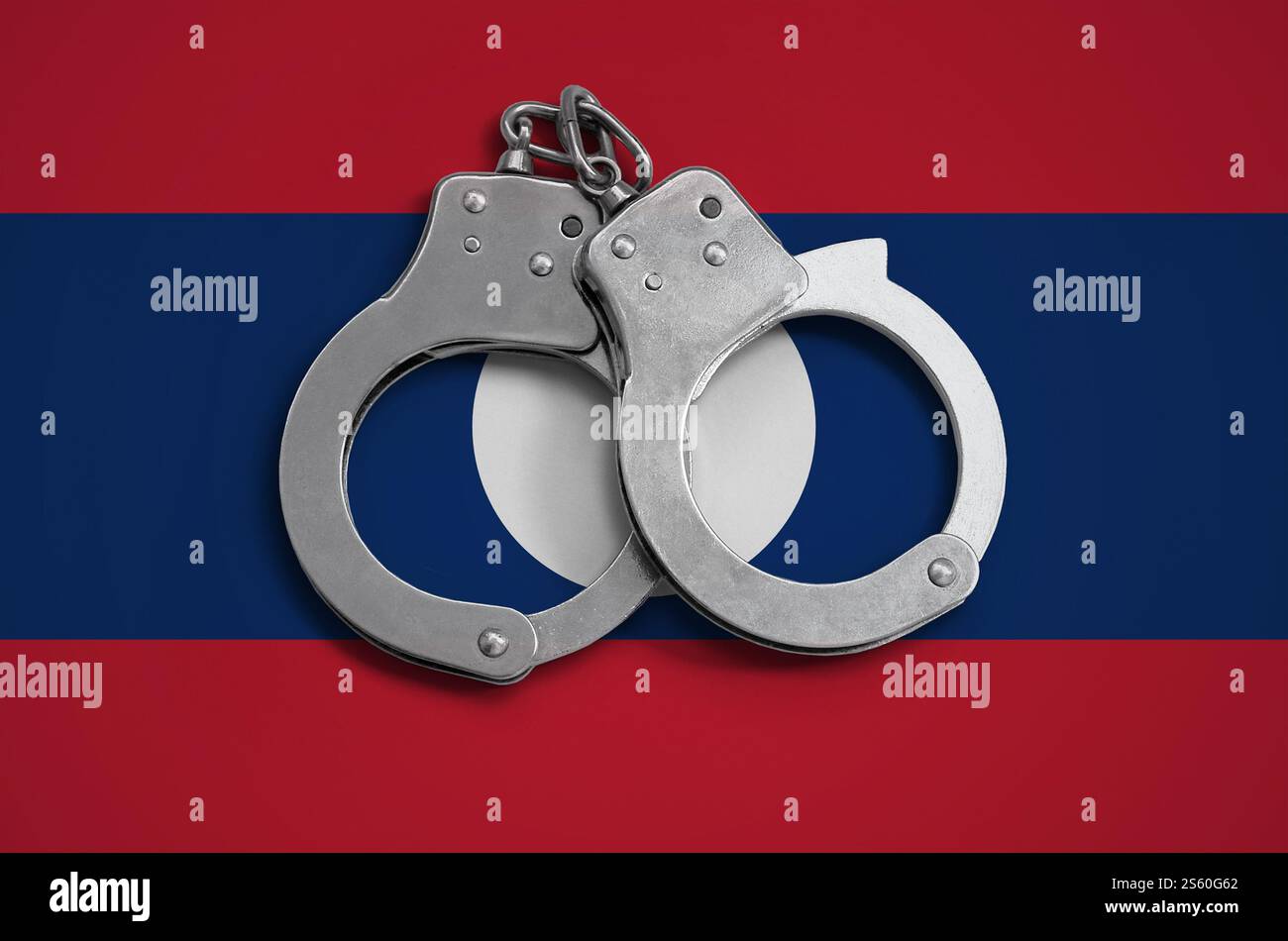 Laos flag and police handcuffs. The concept of observance of the law in ...