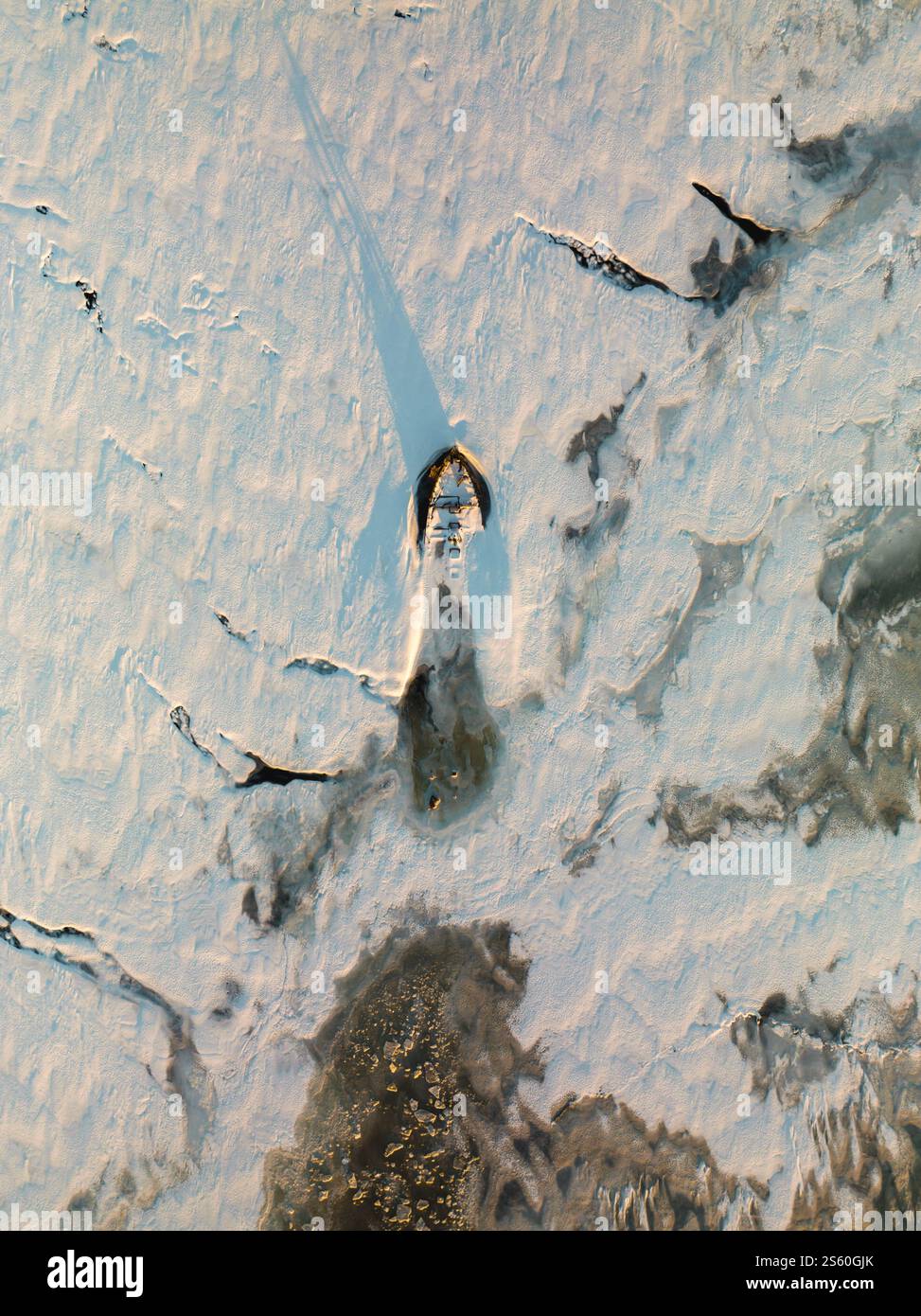 Aerial view of the Clyne Castle shipwreck partially buried in snow in ...