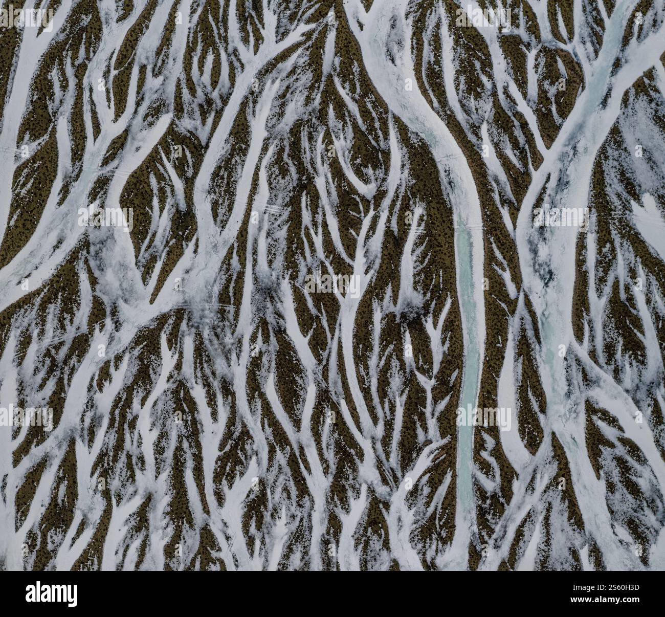 Aerial view of intricate frozen river patterns in South Iceland during ...