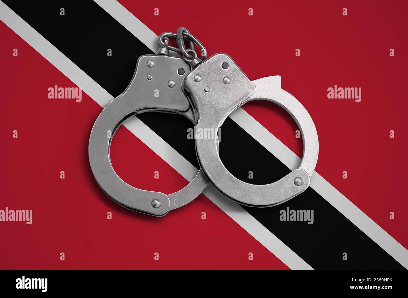 Trinidad and Tobago flag and police handcuffs. The concept of ...