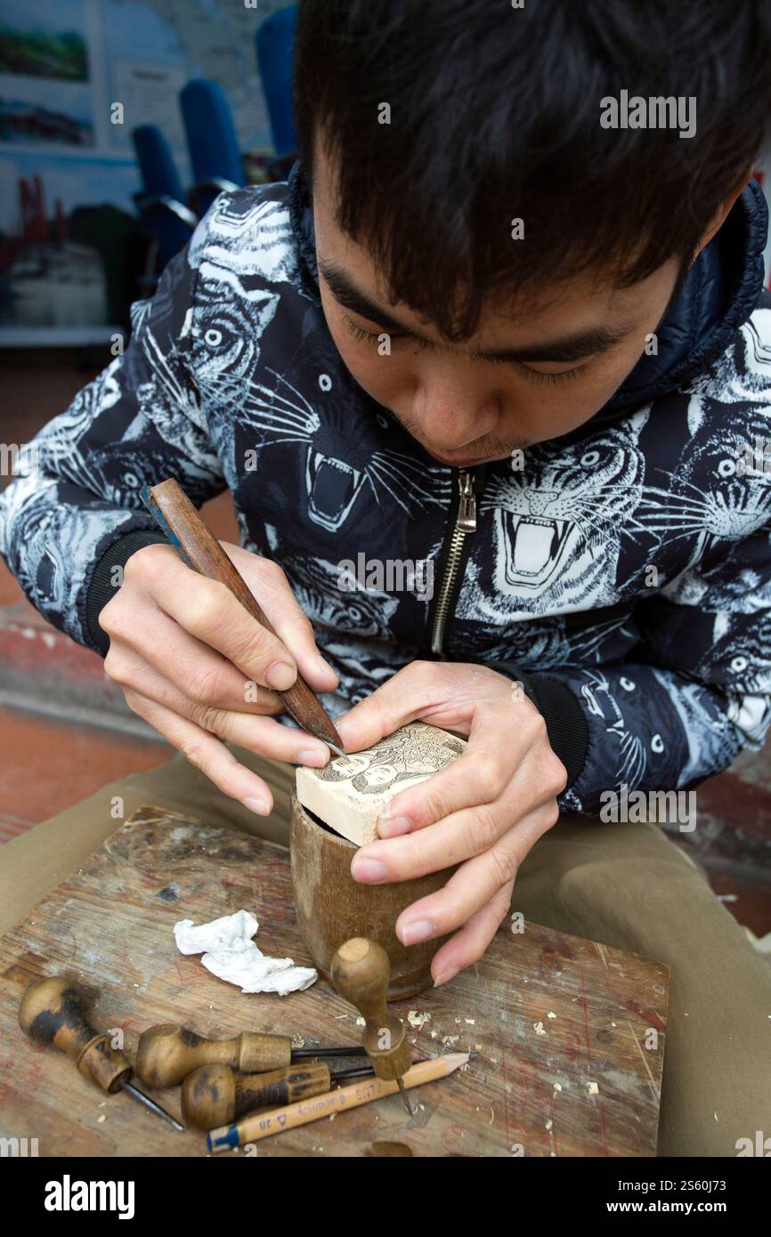 January 27, 2018 - Hanoi, Vietnam: Vietnamese man carving a wooden ...