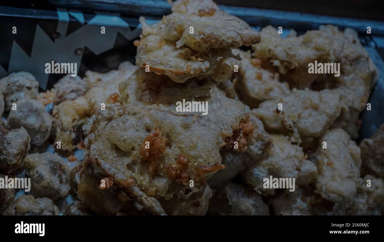 Close up of crispy fried pork rinds in a container, showcasing their ...