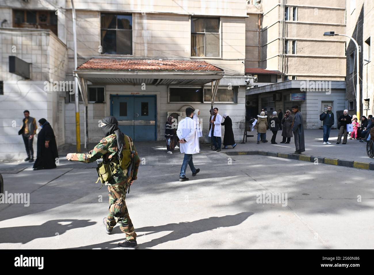 Damaskus, Syria. 15th Jan, 2025. Security forces and doctors stand in ...