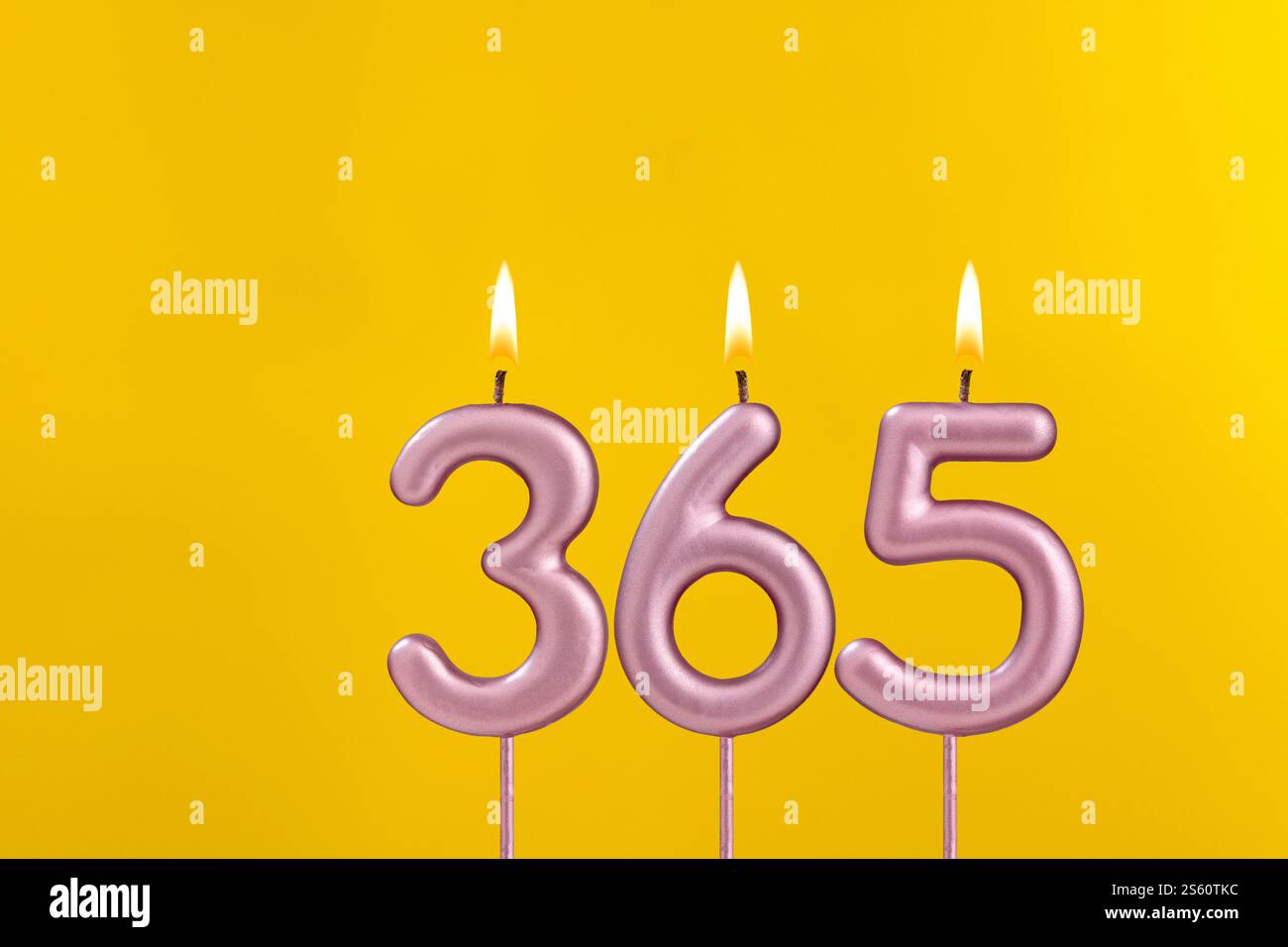 Three candles forming the number 365 - Yellow background Stock Photo ...