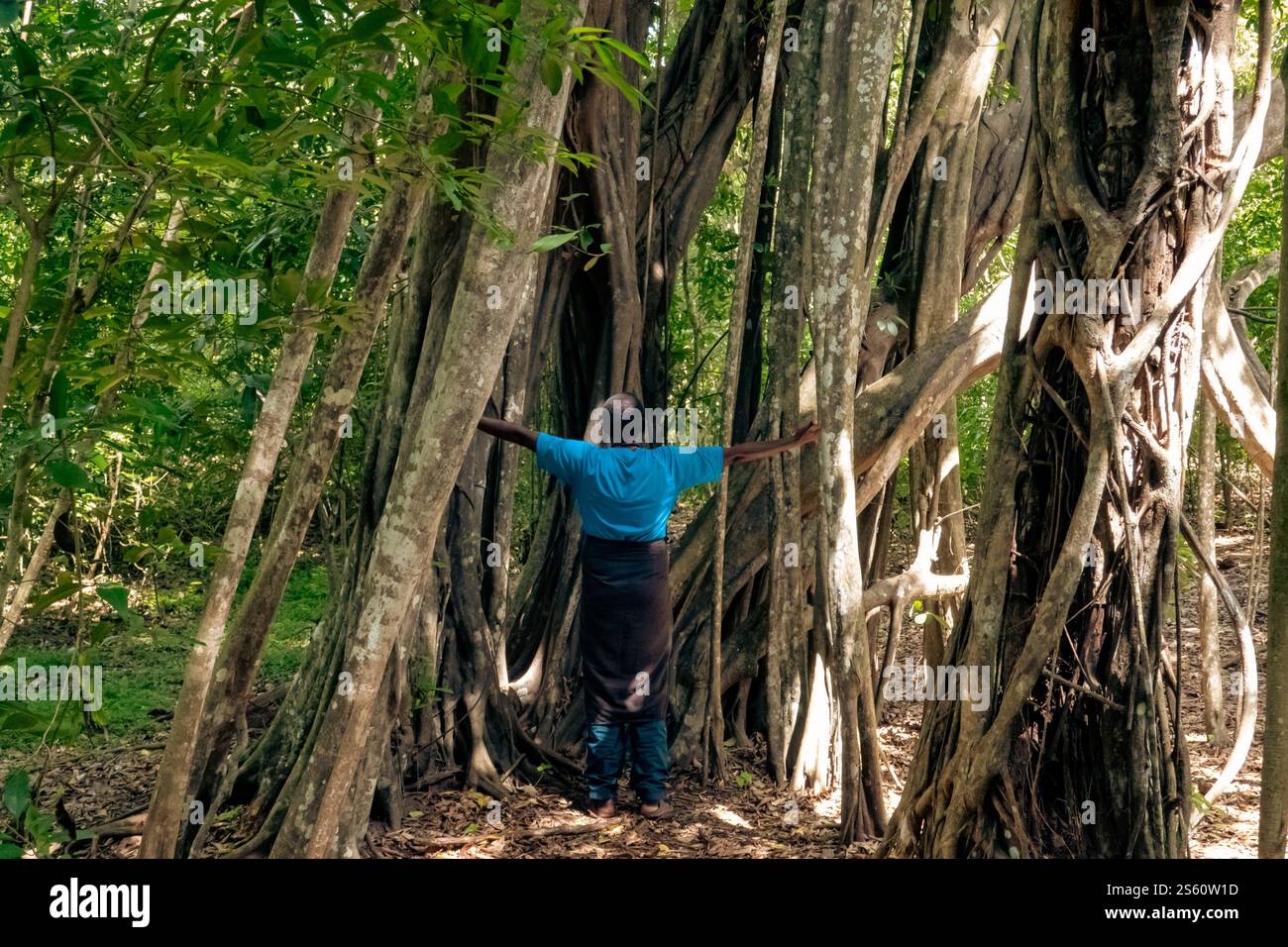 Rear view of man in traditional Digo tribe fabric cloth amidst ...