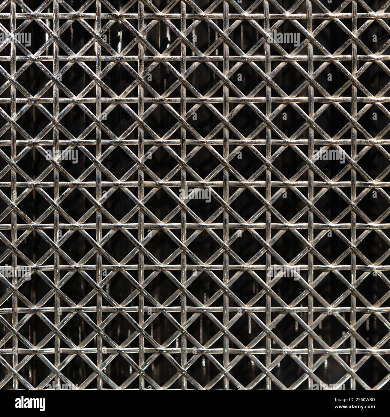 A closeup of a metal grid pattern featuring intricate crossed lines on ...