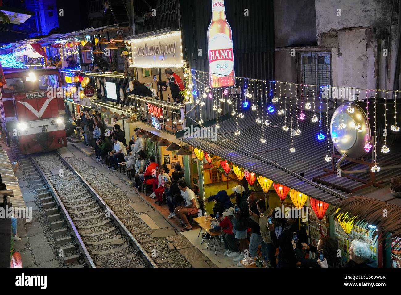A locomotive pulls into the Train Street at the Old Quarter of Hanoi in Vietnam Southeast Asia ...