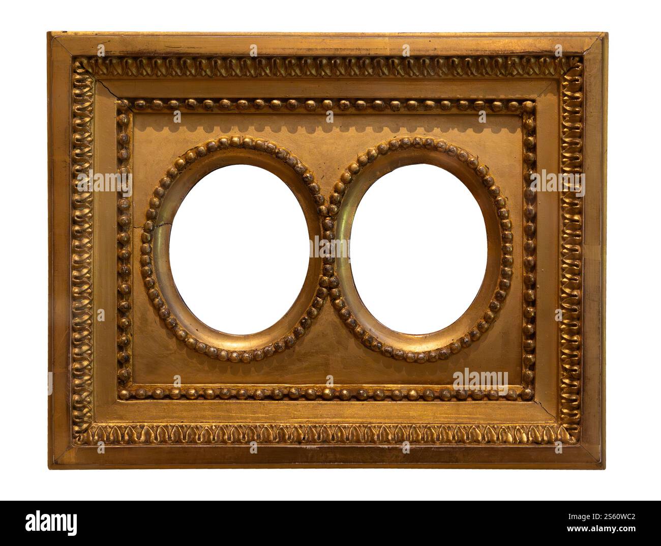 A decorative gilded frame featuring circular openings and intricate ...