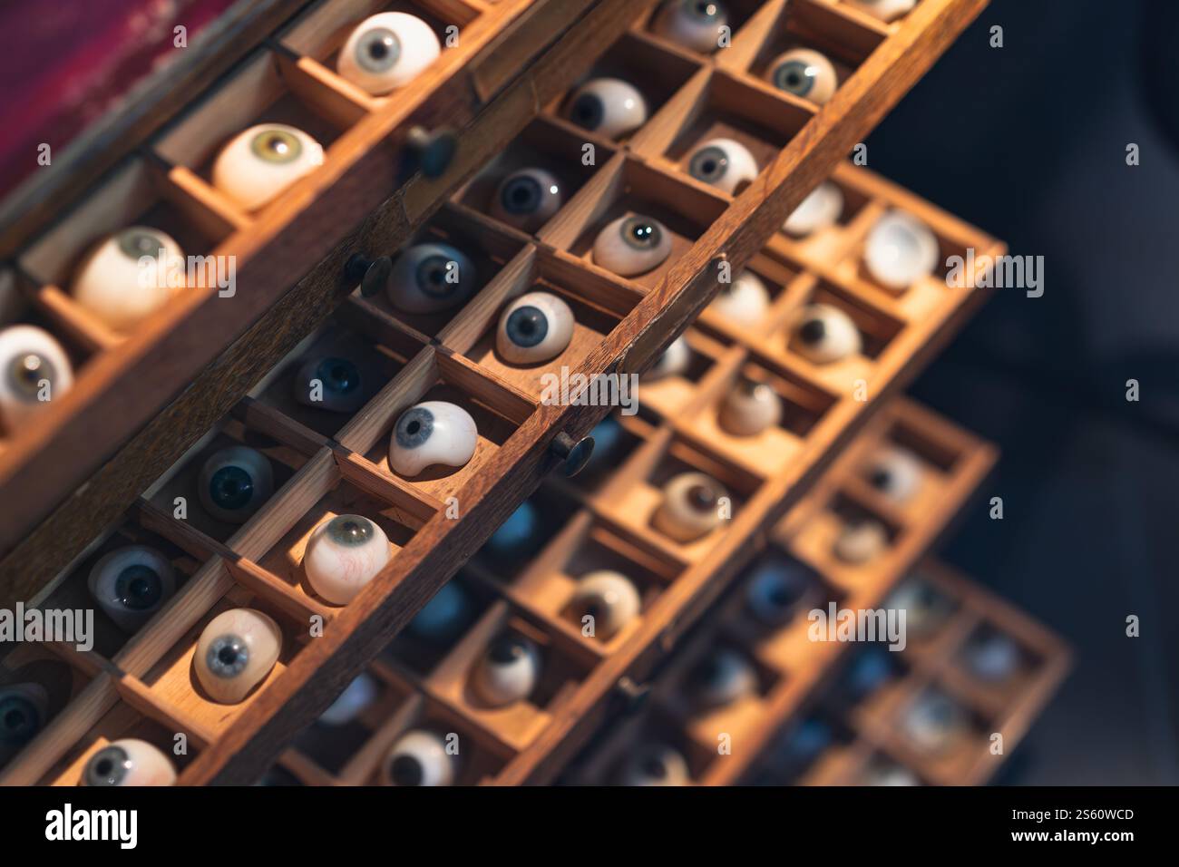 Collection of prosthetic eyeballs stored in wooden drawers viewed ...