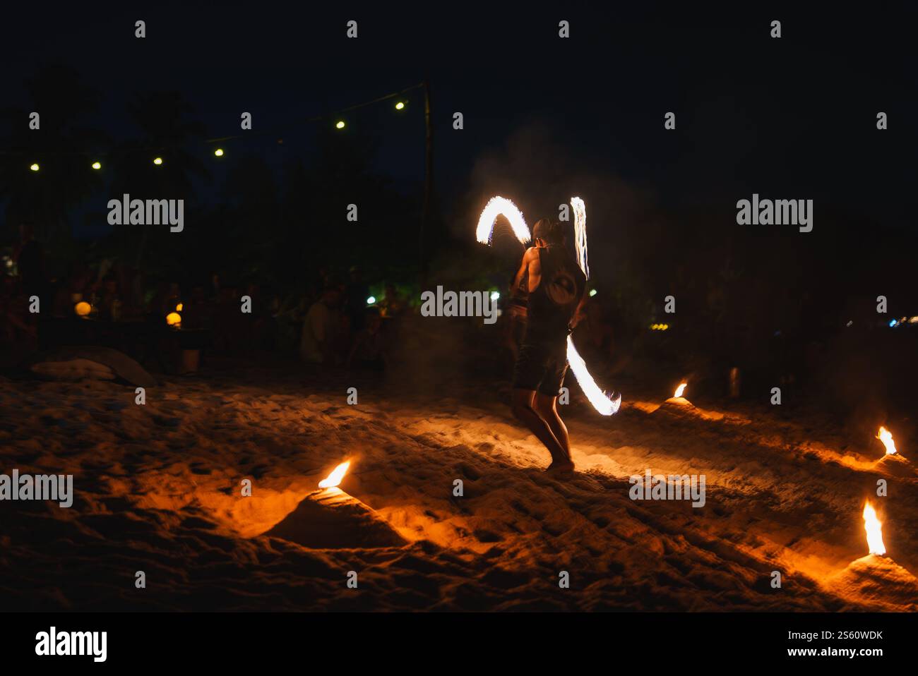 Fire Performer Spinning Fiery Props on a Tropical Beach at Night Stock ...