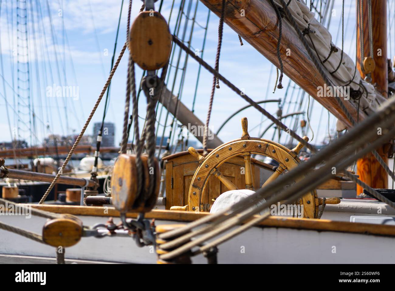 A side perspective of the ship rigging and wooden wheel showcasing ...
