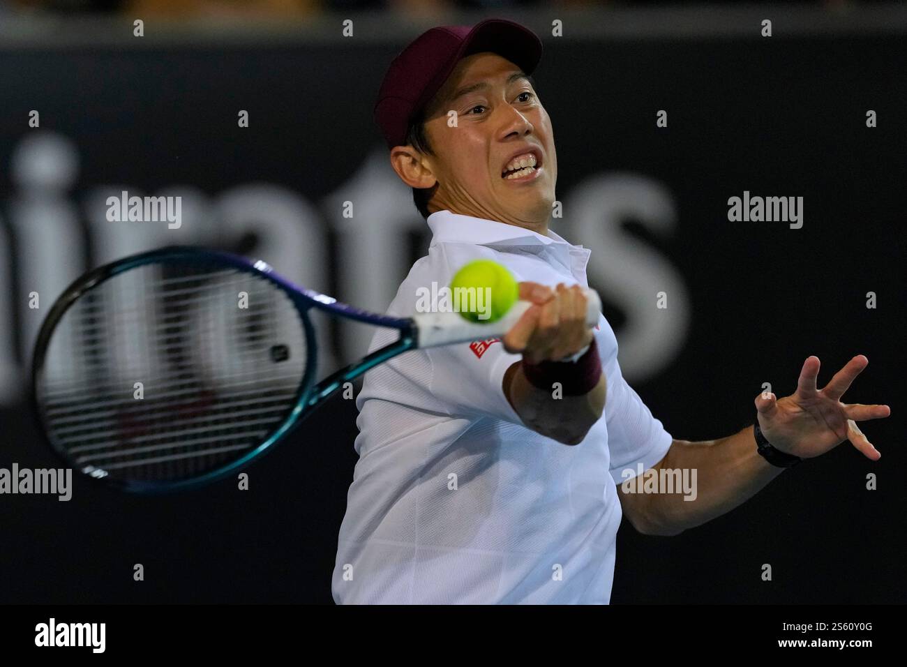 Kei Nishikori of Japan plays a forehand return to Tommy Paul of the U.S ...