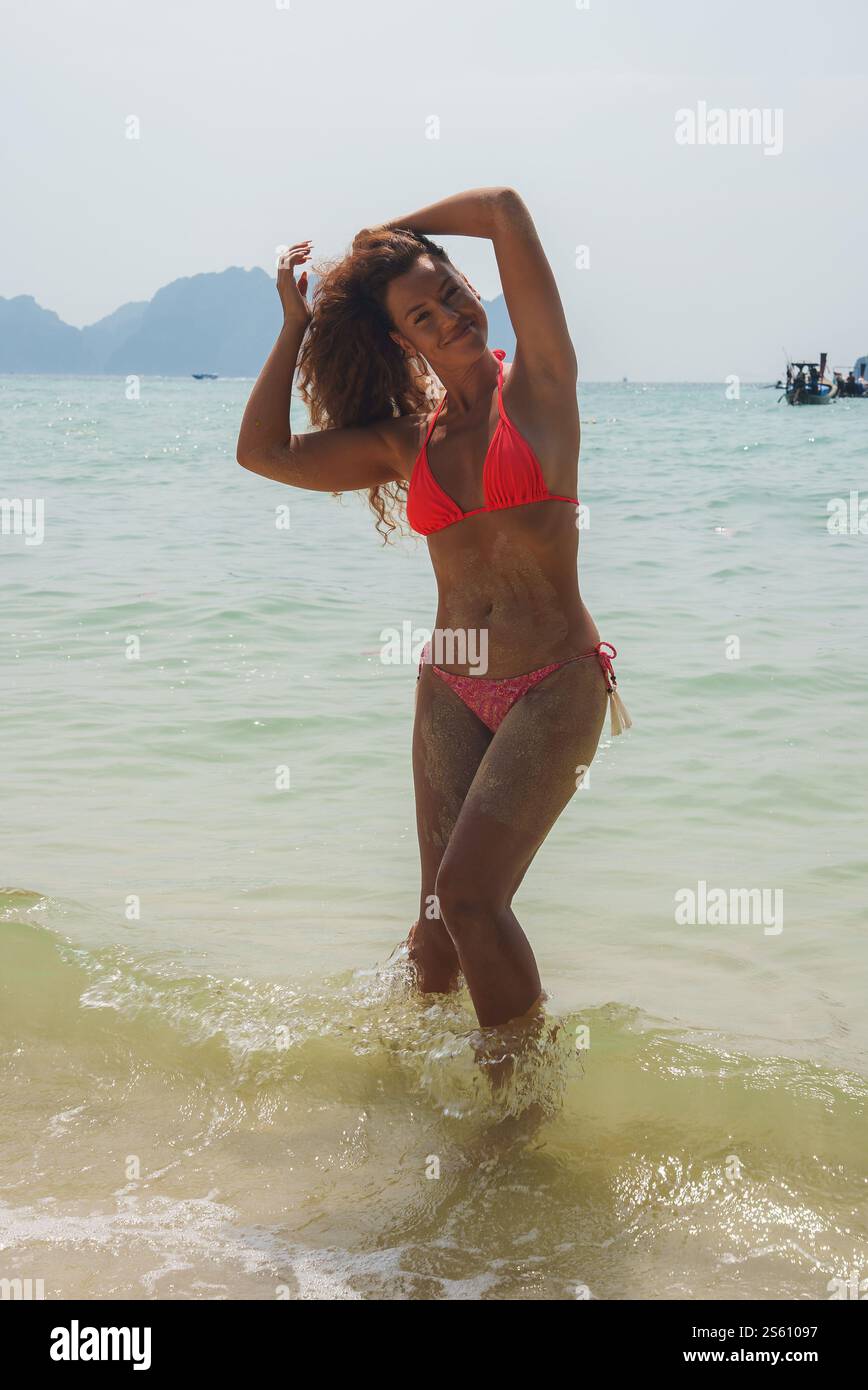 Woman in Red Bikini Posing on a Beach with Koh Phi Phi Islands Stock Photo - Alamy