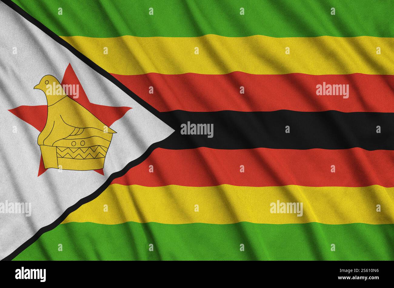 Zimbabwe flag is depicted on a sports cloth fabric with many folds ...