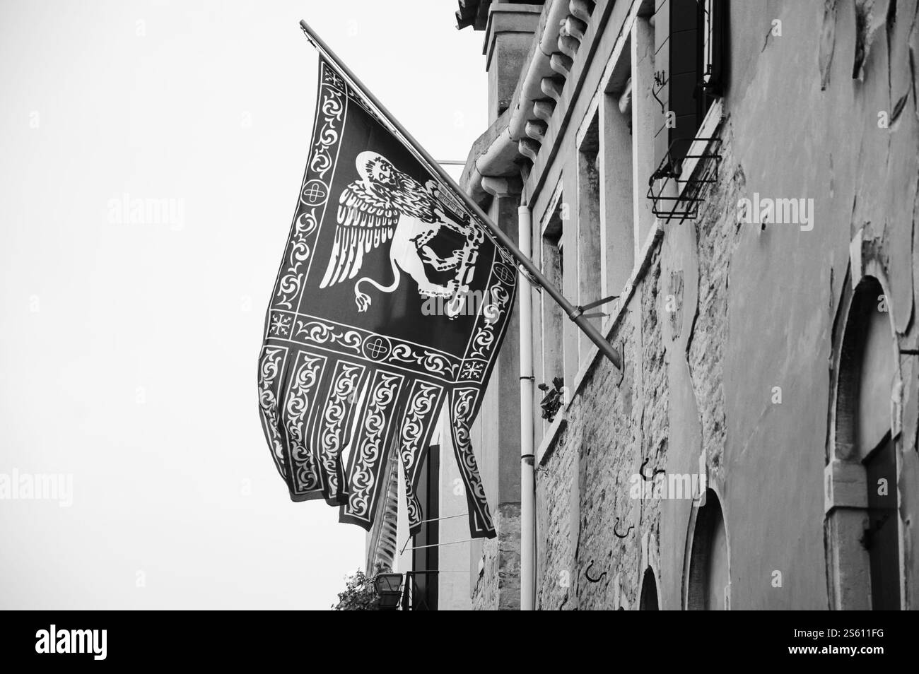 Venice, Italy. Flag of Venice with winged lion on old Venetian building ...