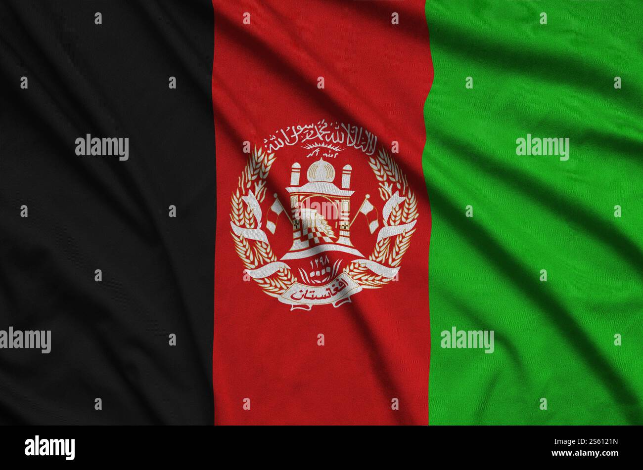Afghanistan flag is depicted on a sports cloth fabric with many folds ...