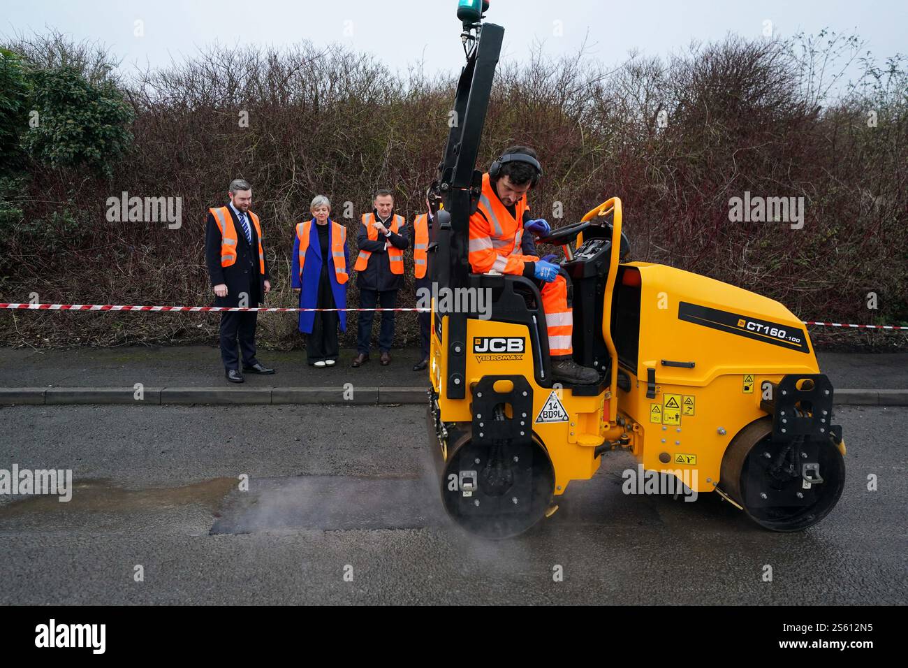 Roads minister Lilian Greenwood observes a pothole being repaired ...