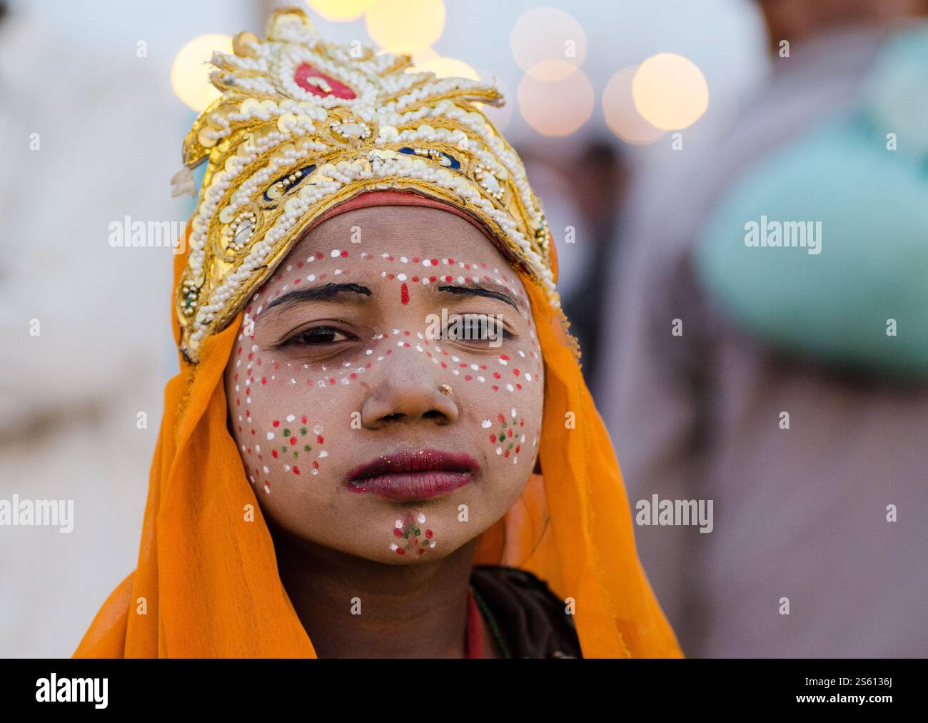Girl with traditional makeup at a cultural festival among gathering ...