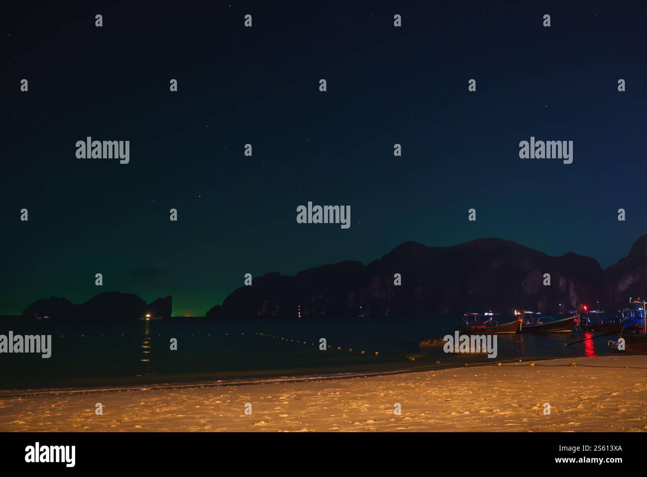 Nighttime Beach View with Long Tail Boats and Limestone Cliffs in ...