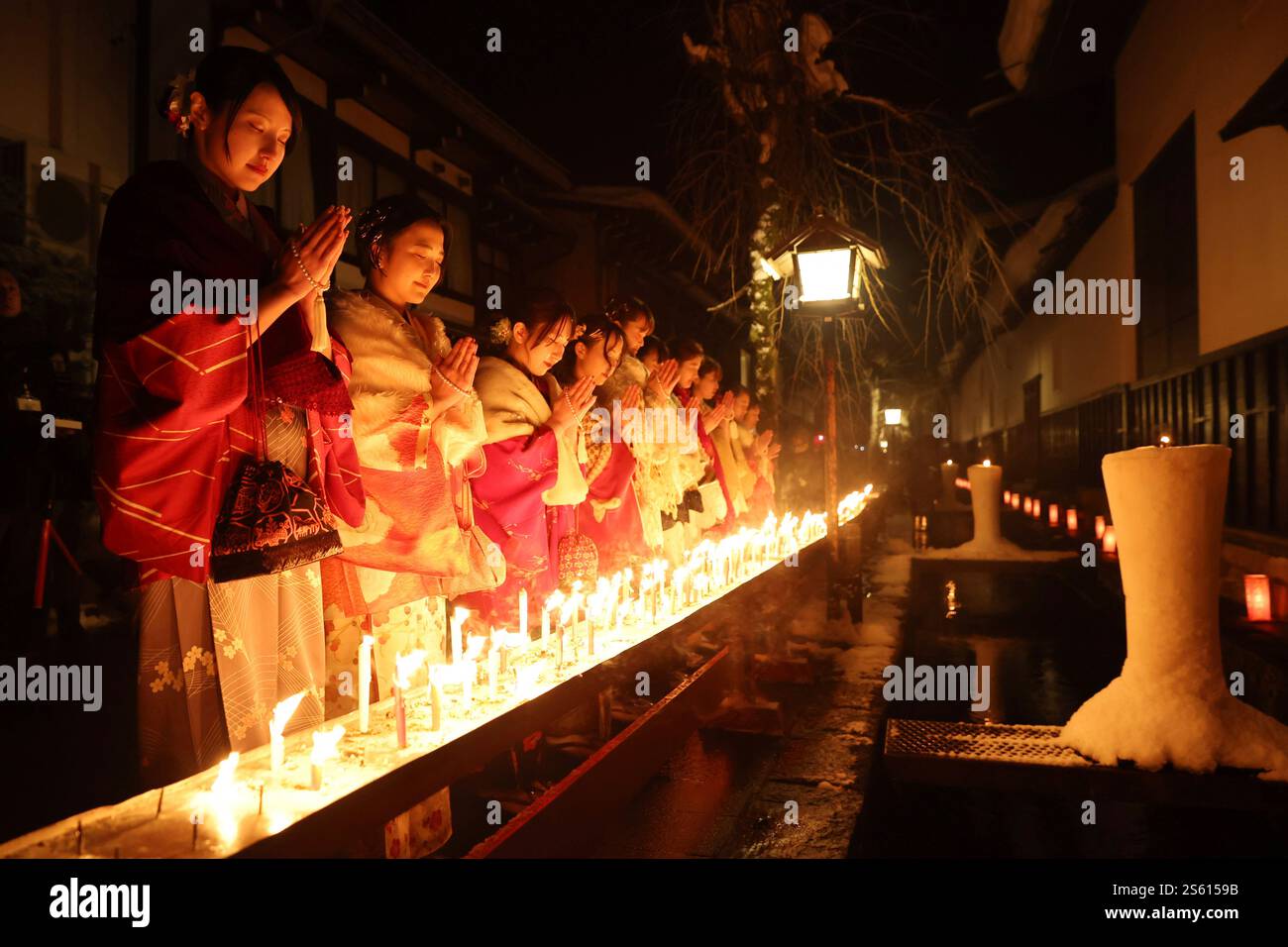 Women clad in kimono (Japanese traditional clothing) pray for their ...