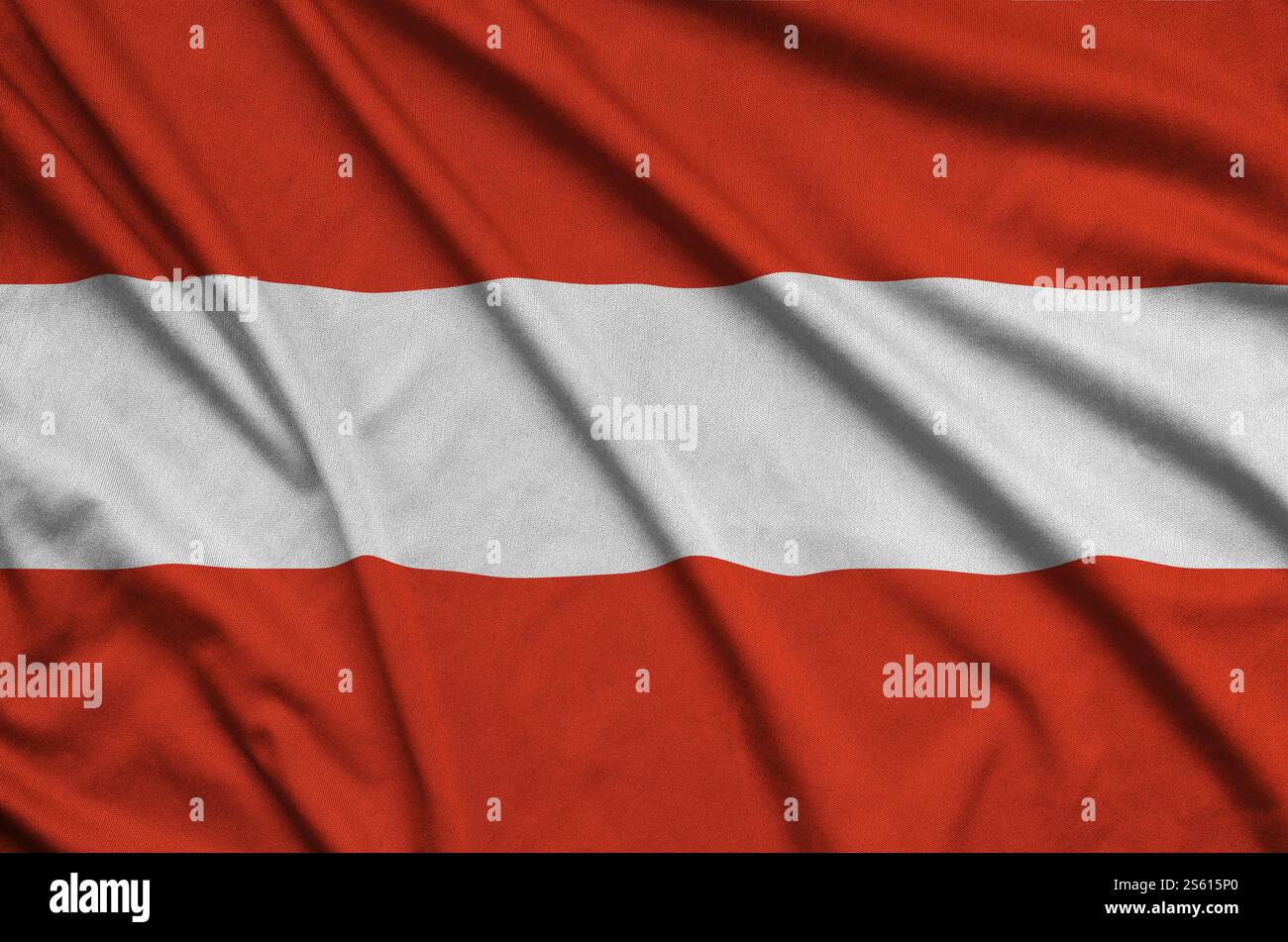 Austria flag is depicted on a sports cloth fabric with many folds ...