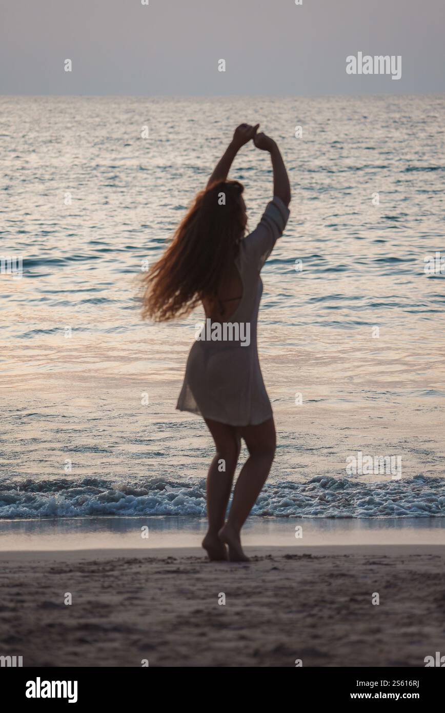 Woman dancing gracefully sunset beach hi-res stock photography and ...