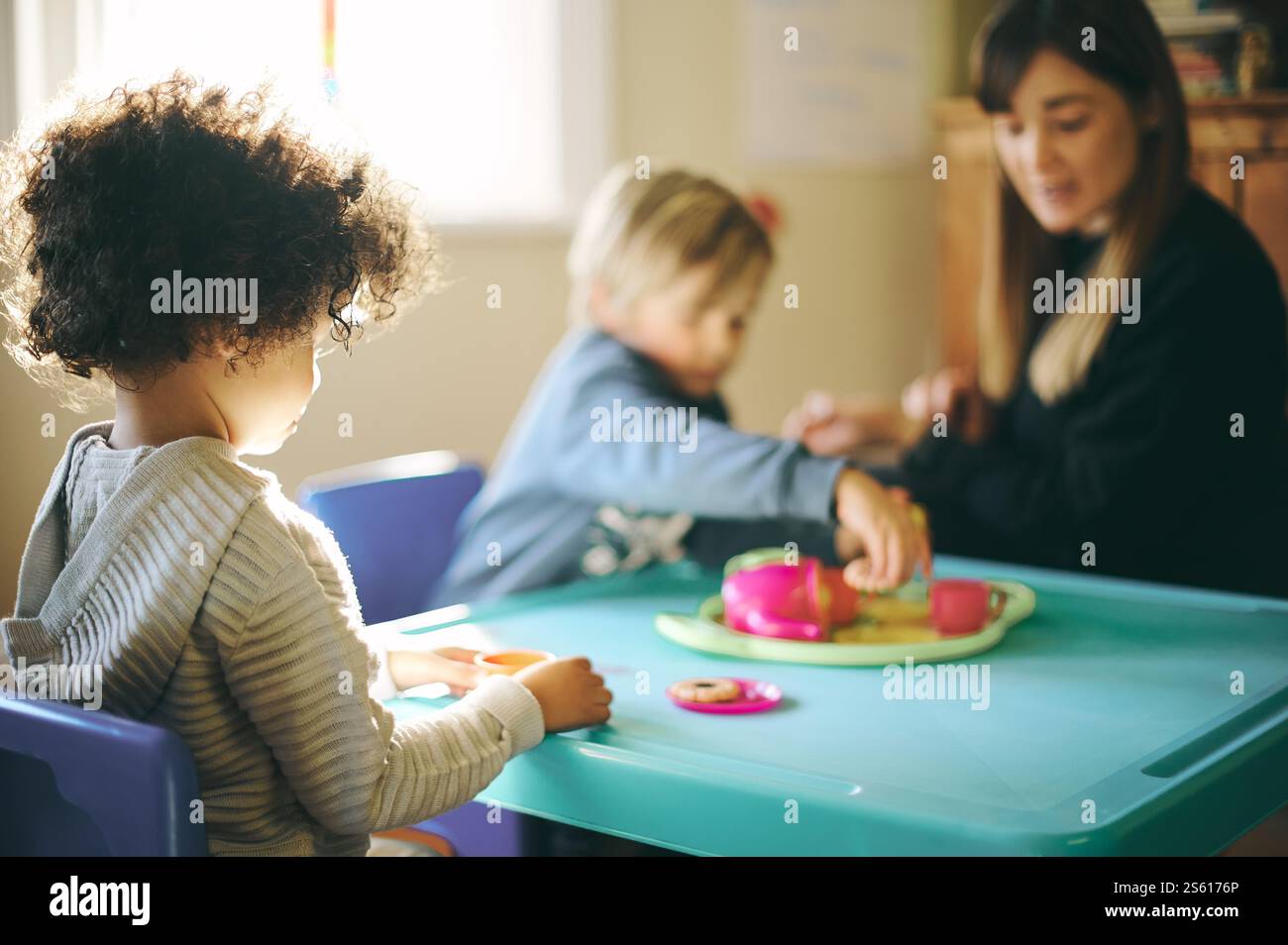 Mother, kids and play tea party in home, having fun and bonding ...