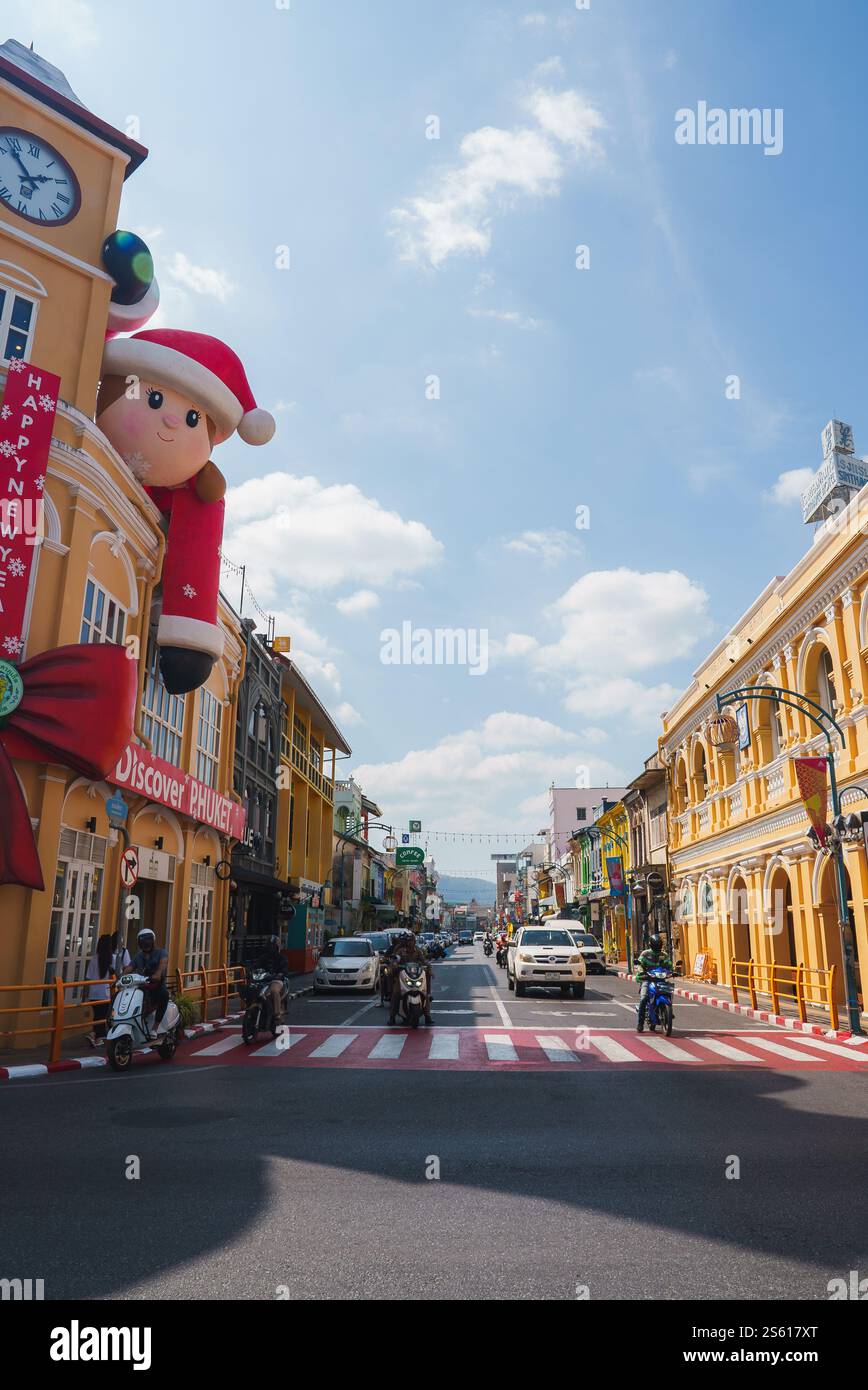 A vibrant street in Phuket, Thailand, with colonial style yellow ...