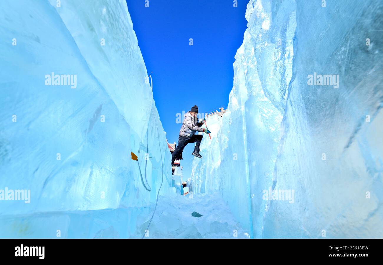 An ice sculptor works on an ice sculpture in Zhangye city, Gansu ...