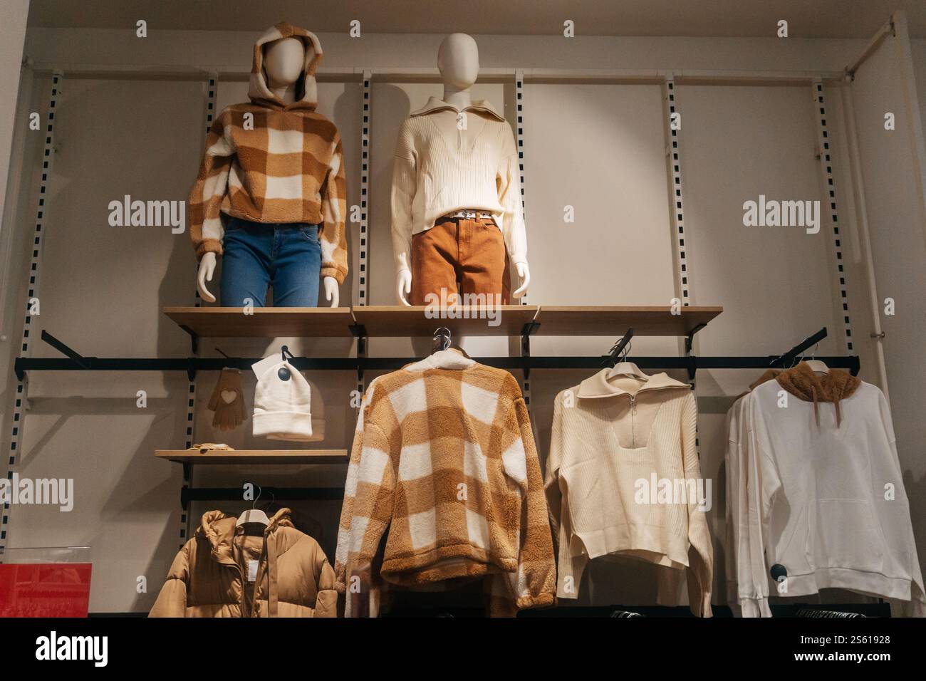 autumn items on the store shelf. a showcase with warm hoodies in a ...