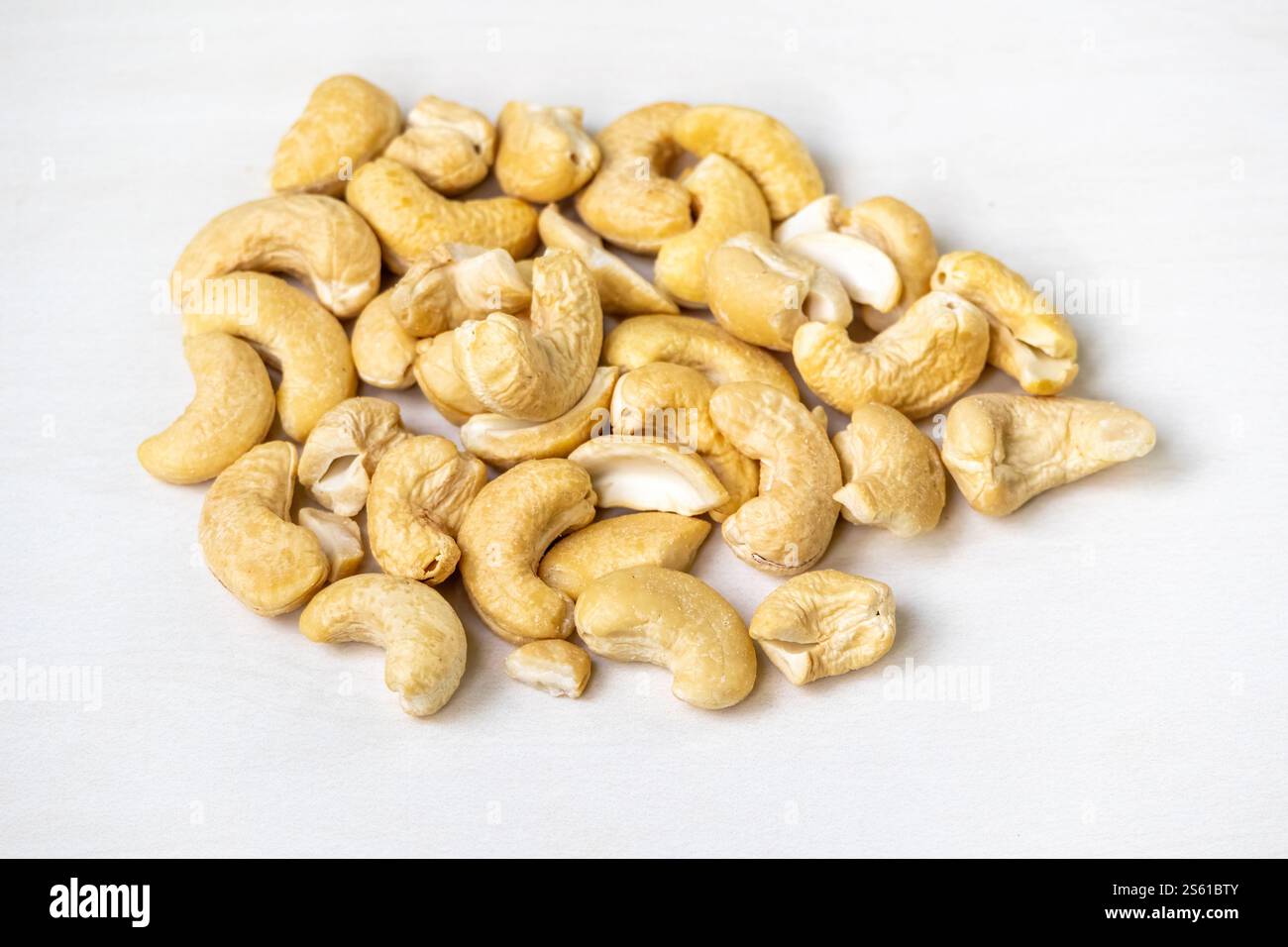 Cashew nuts, known as Kaju Badam in Bengali, are isolated on a white ...