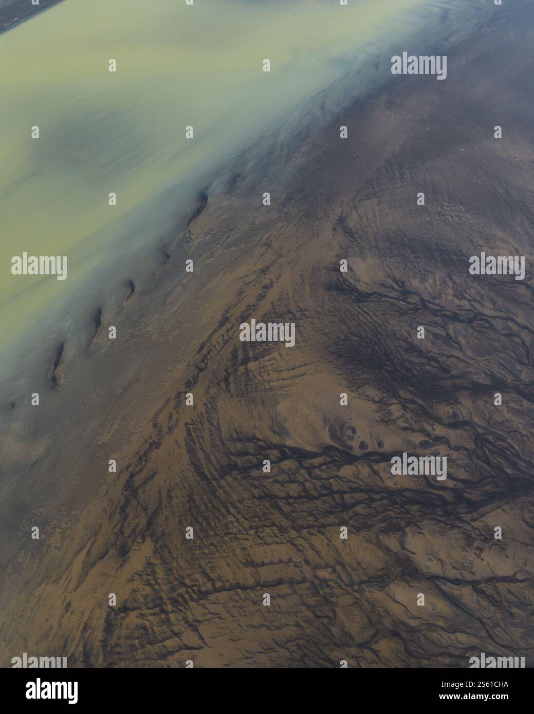 Aerial view of striking volcanic patterns and sediment-rich waters in ...