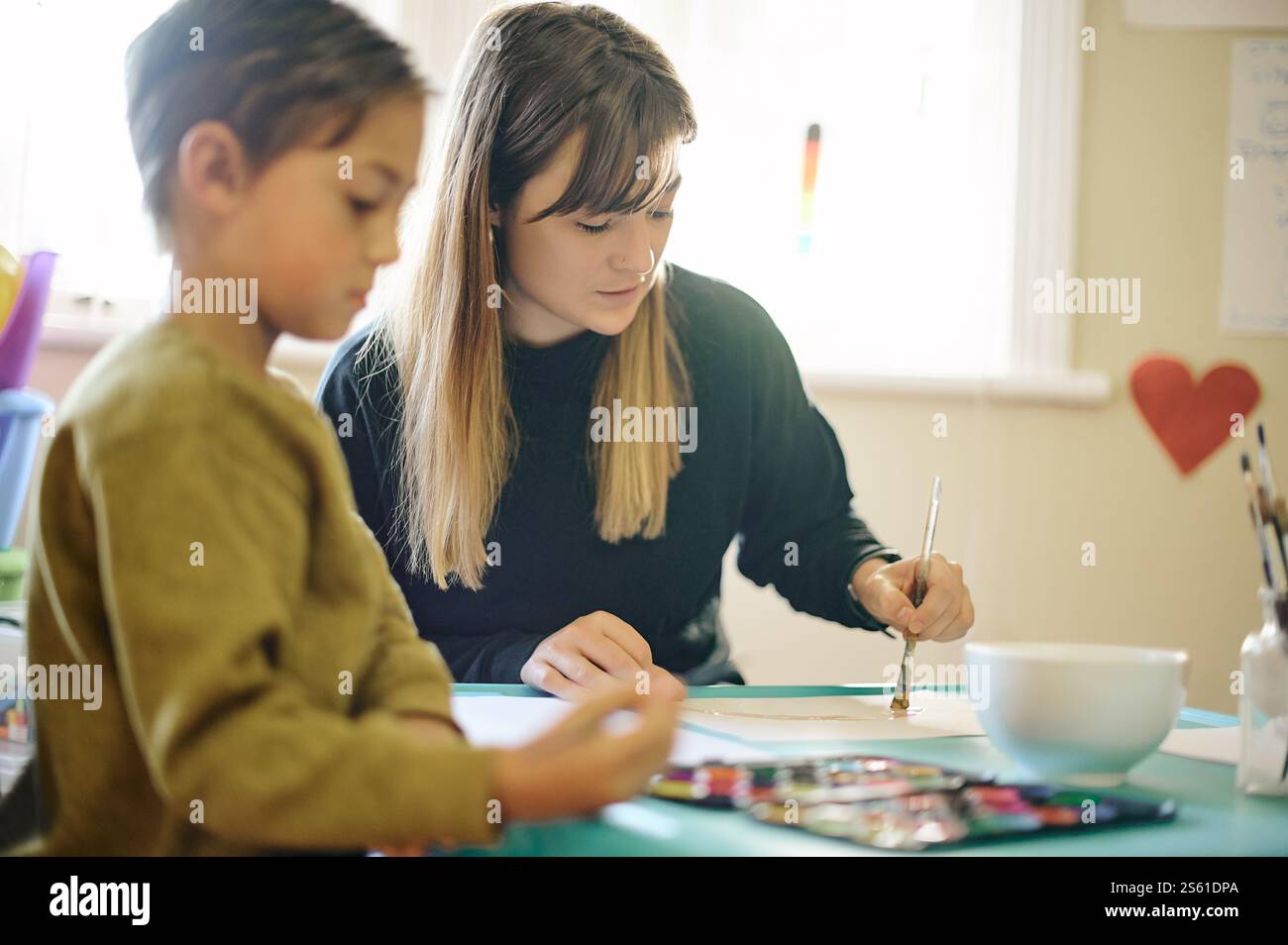 Painting, picture and art with teacher and child in classroom for ...
