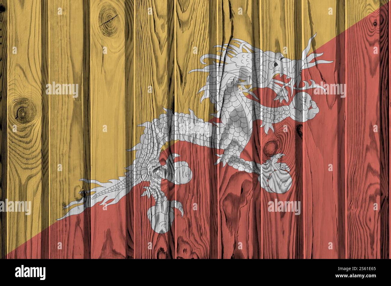 Bhutan flag depicted in bright paint colors on old wooden wall close up ...