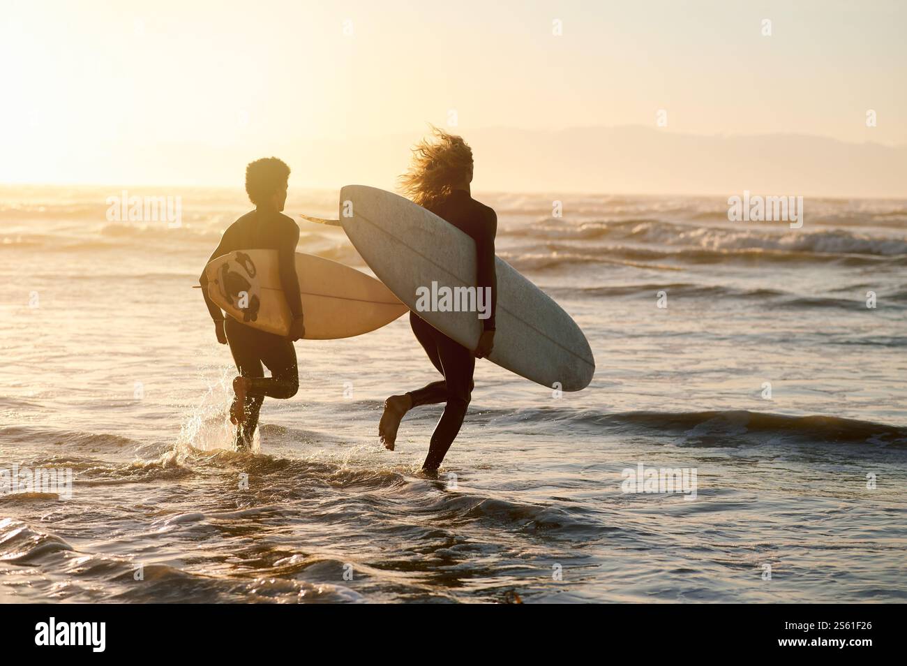 Surfing, friends and running at sunset beach for waves, freedom and ...