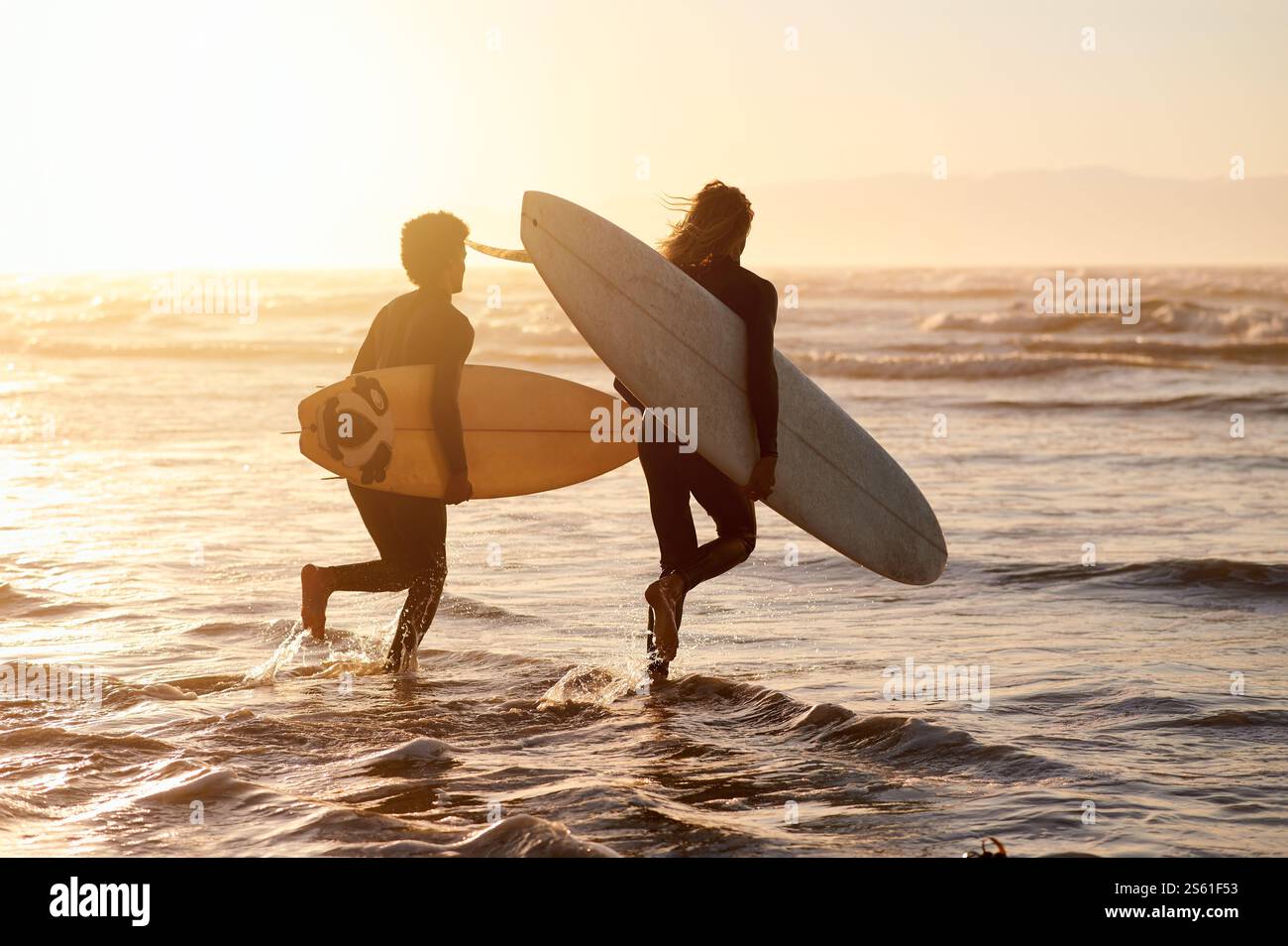 Men, surfer friends and running at sunset beach for waves, freedom and ...