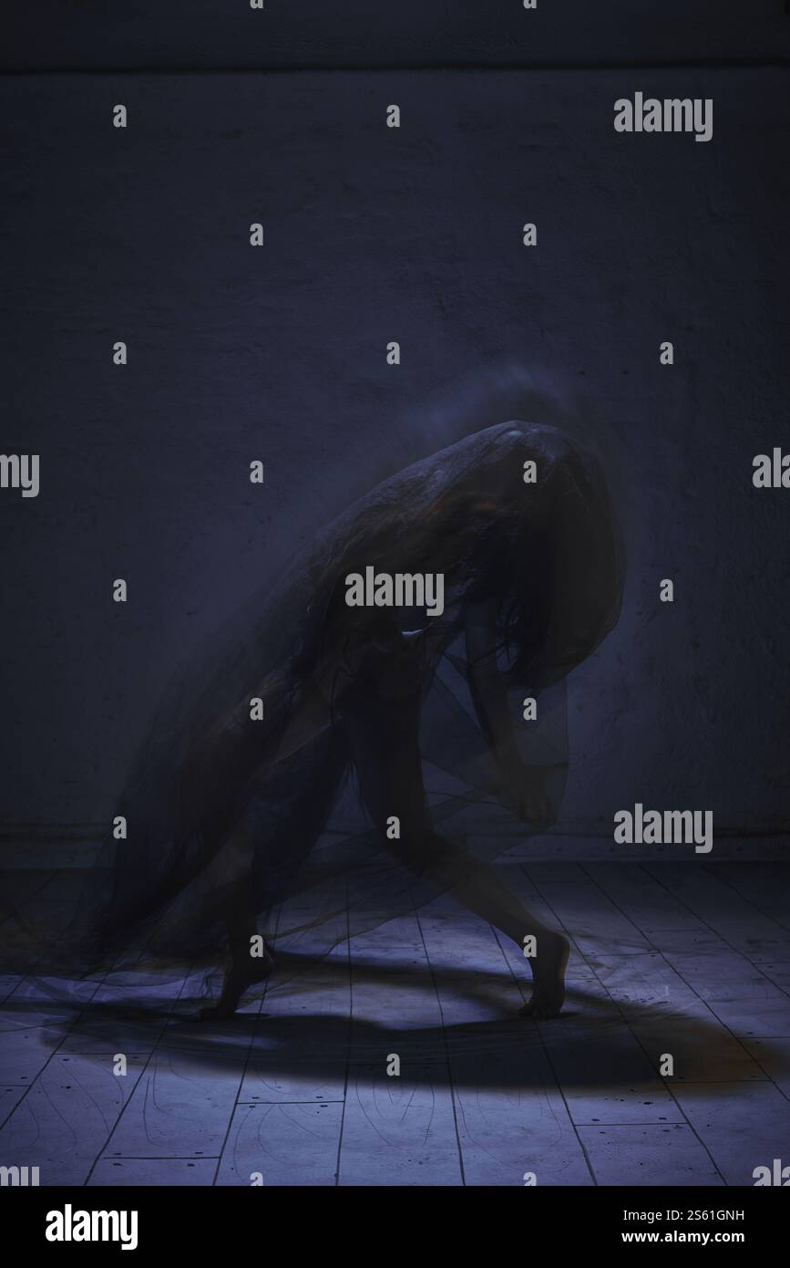 Horror scene with a woman cloaked in dark veil, standing in a dynamic ...