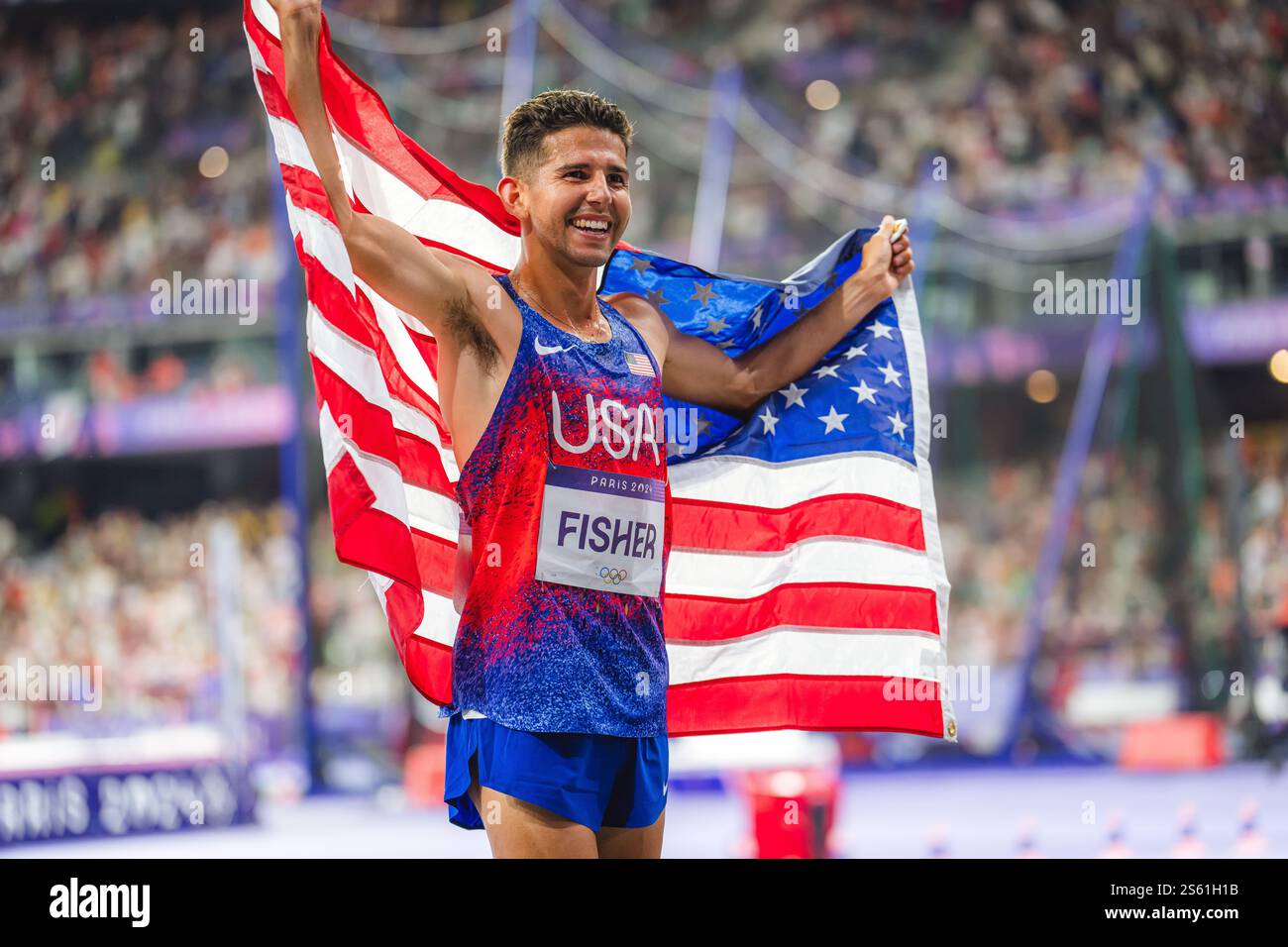 Grant Fisher celebrating her medal with her country's flag at the Paris ...