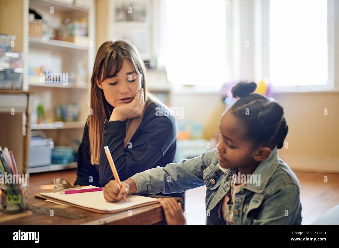 Teacher, kids help and drawing in a house learning and writing for ...