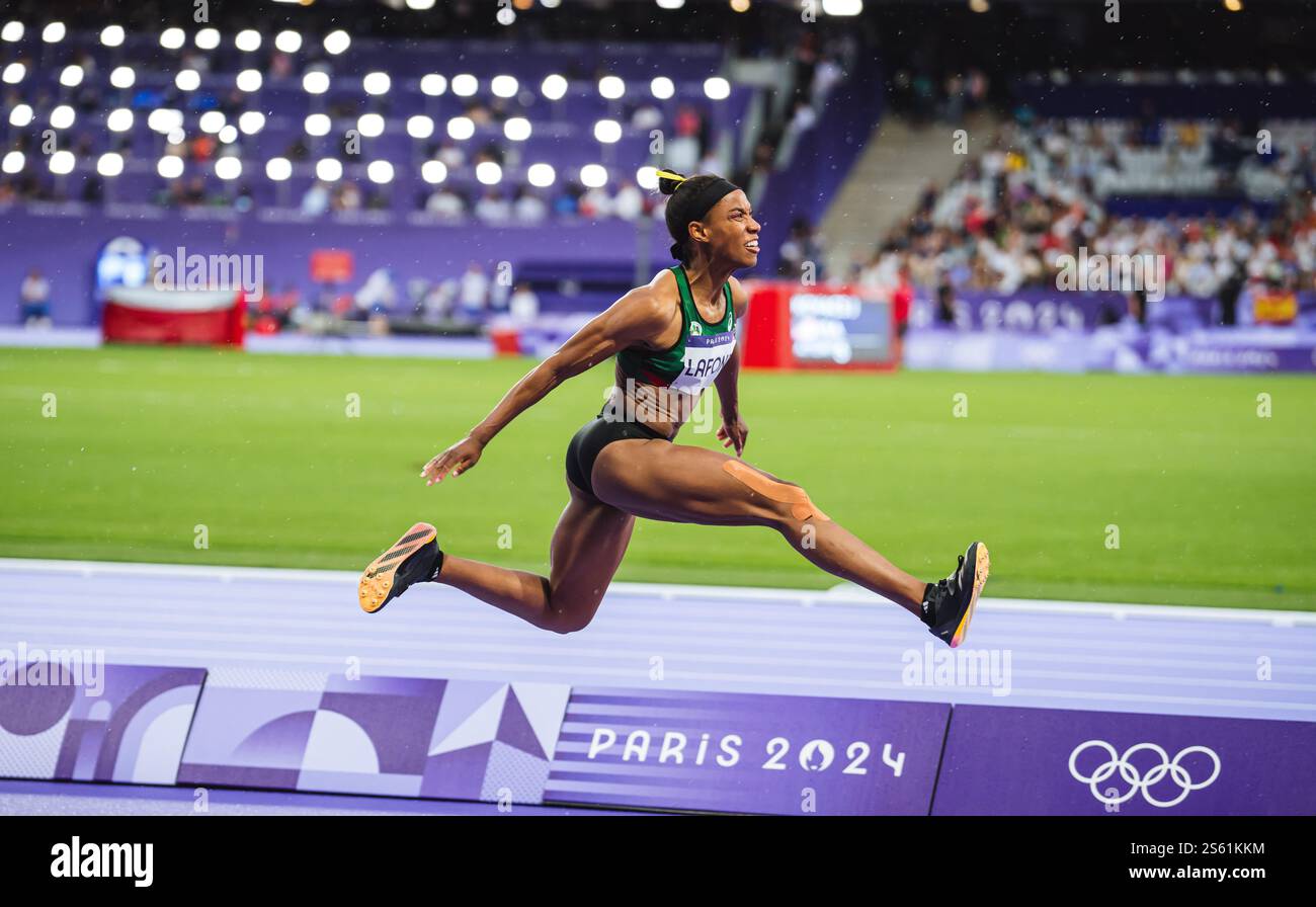 Thea LaFond celebrating her medal with her country's flag at the Paris ...