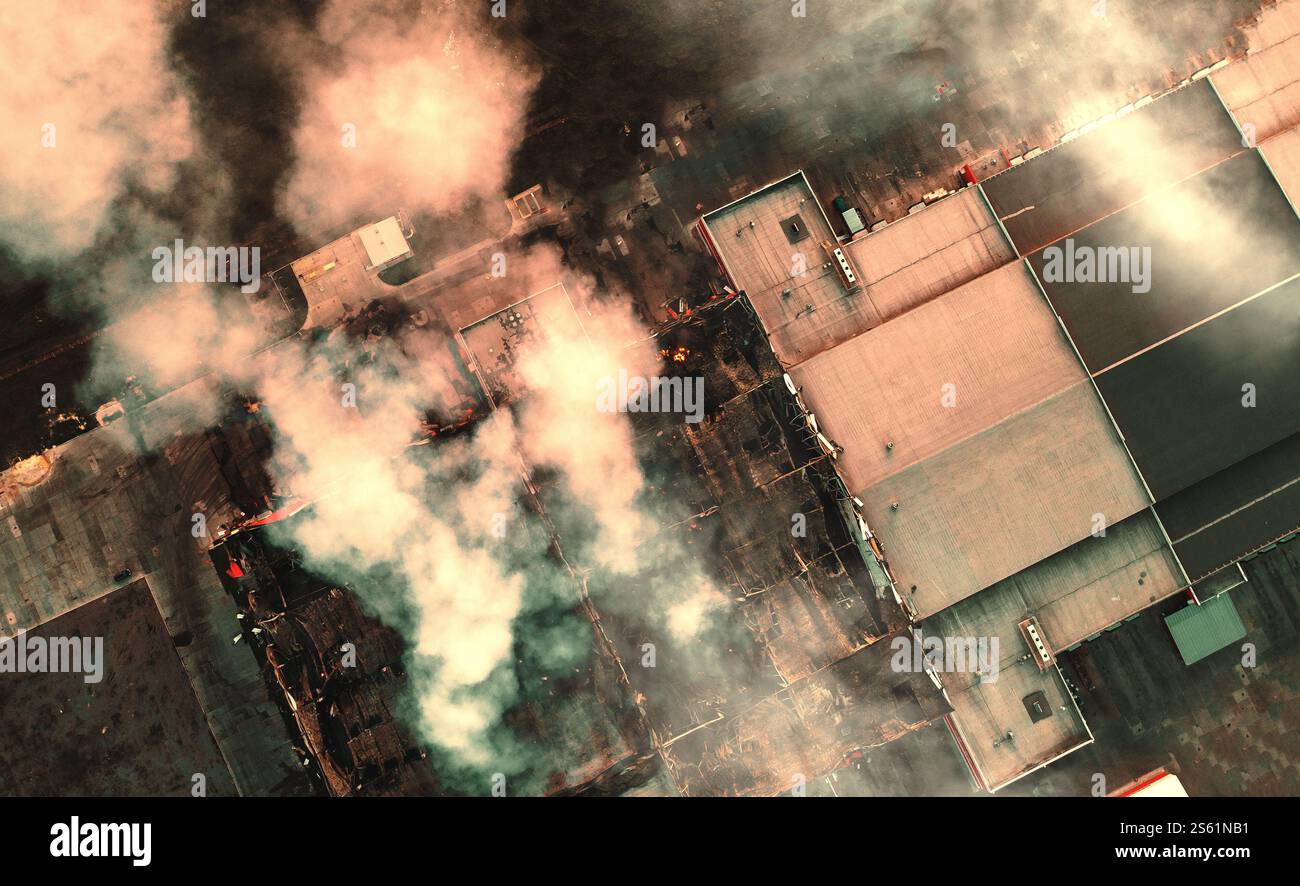 Aerial top view of city block on fire with thick smoke rising, damaged ...