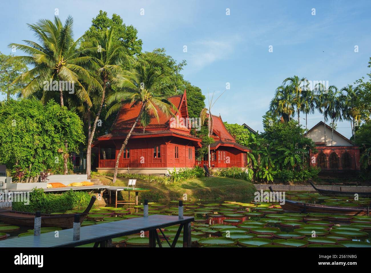 Traditional Thai Red Wooden Buildings with Ornate Roofs and Pond Stock ...