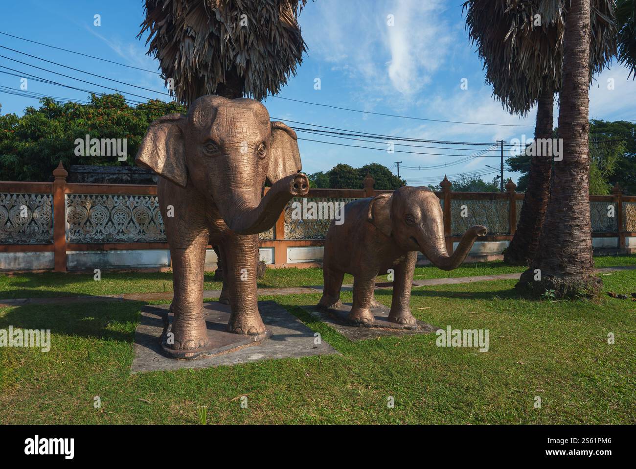 Bronze Elephant Statues in a Tropical Setting with Palm Trees Stock ...