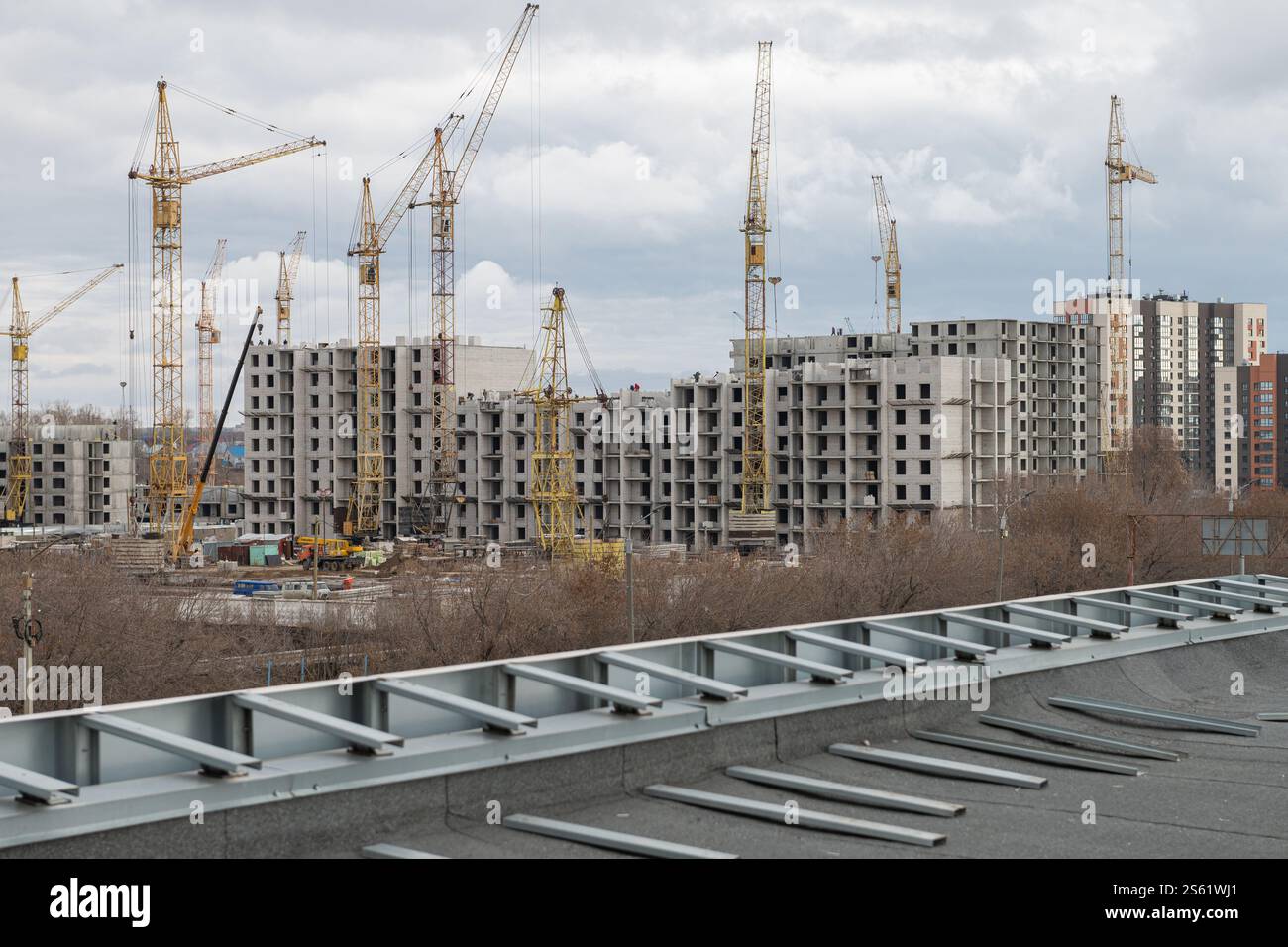 A large urban construction site with multiple tower cranes erecting ...