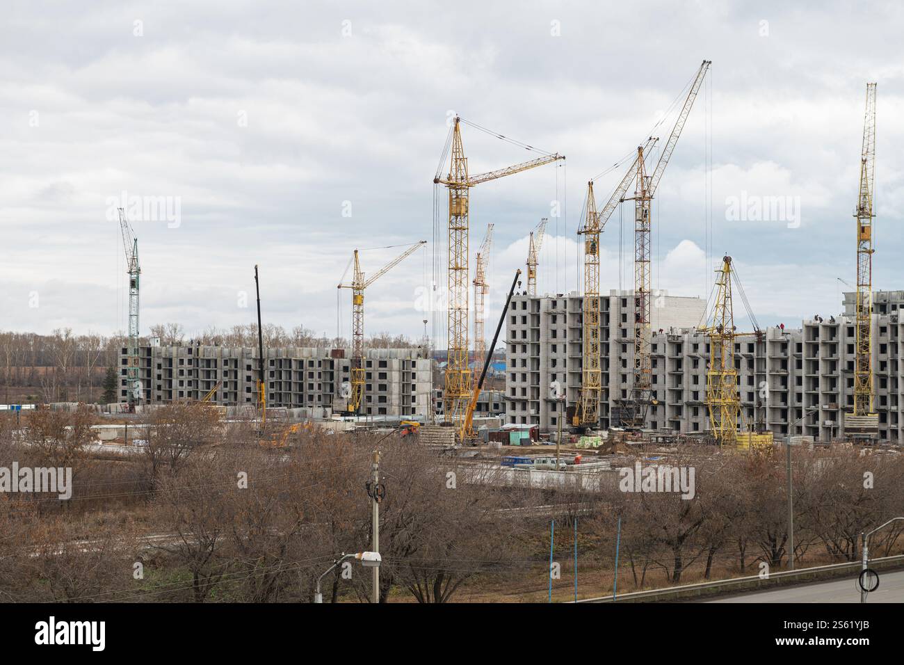 A large urban construction site with multiple tower cranes erecting ...